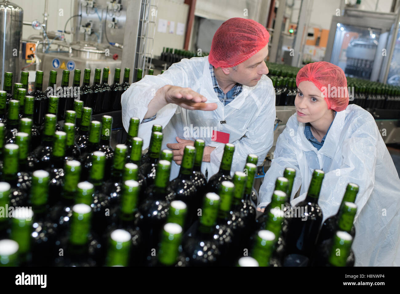 brewery team wearing a uniform inside the workshop Stock Photo - Alamy