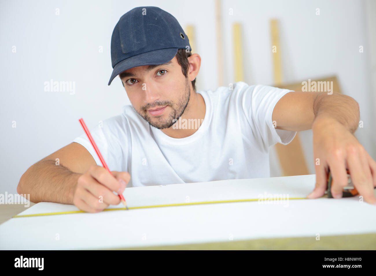 male carpenter working with wood pencil at work place Stock Photo - Alamy