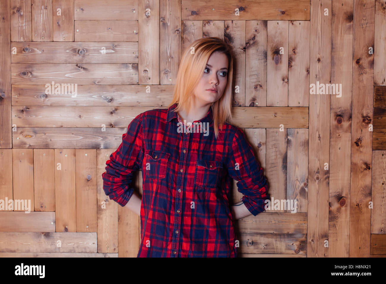 Pretty hipster girl near the wooden wall in loft style room Stock Photo ...