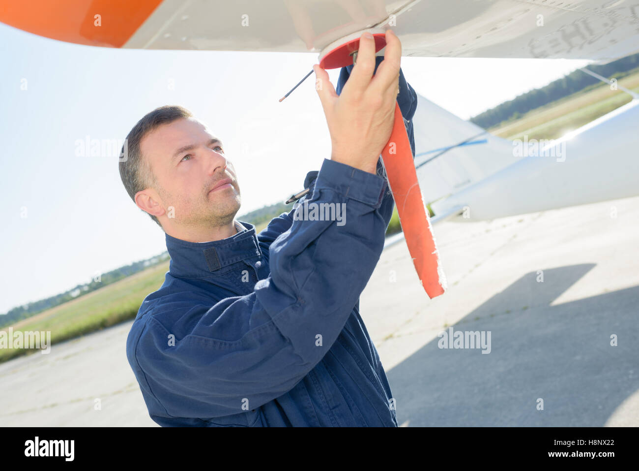engineer fixing an airplane wing Stock Photo - Alamy