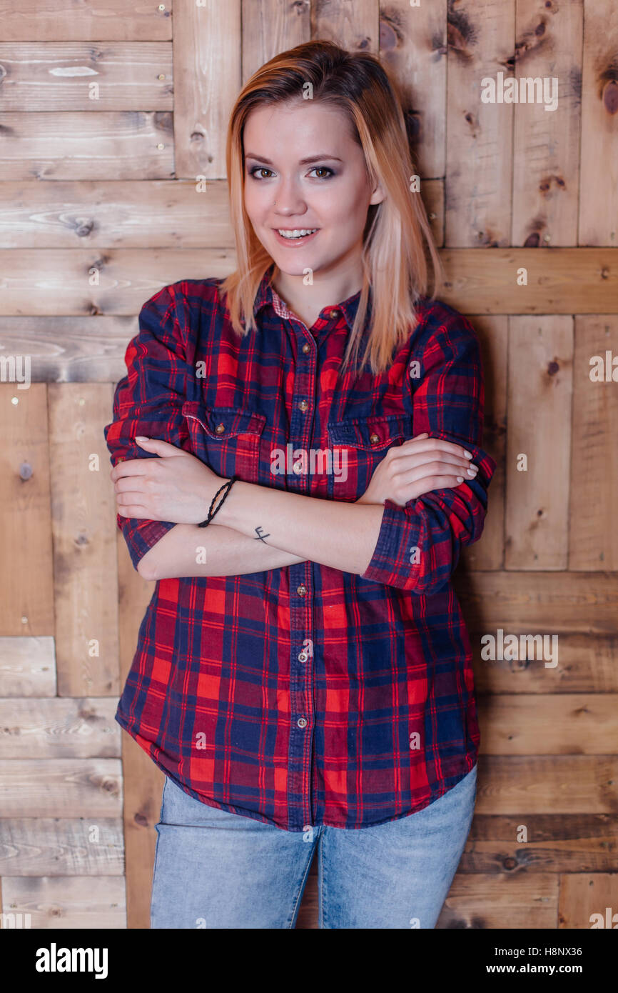 Pretty hipster girl near the wooden wall in loft style room Stock Photo ...