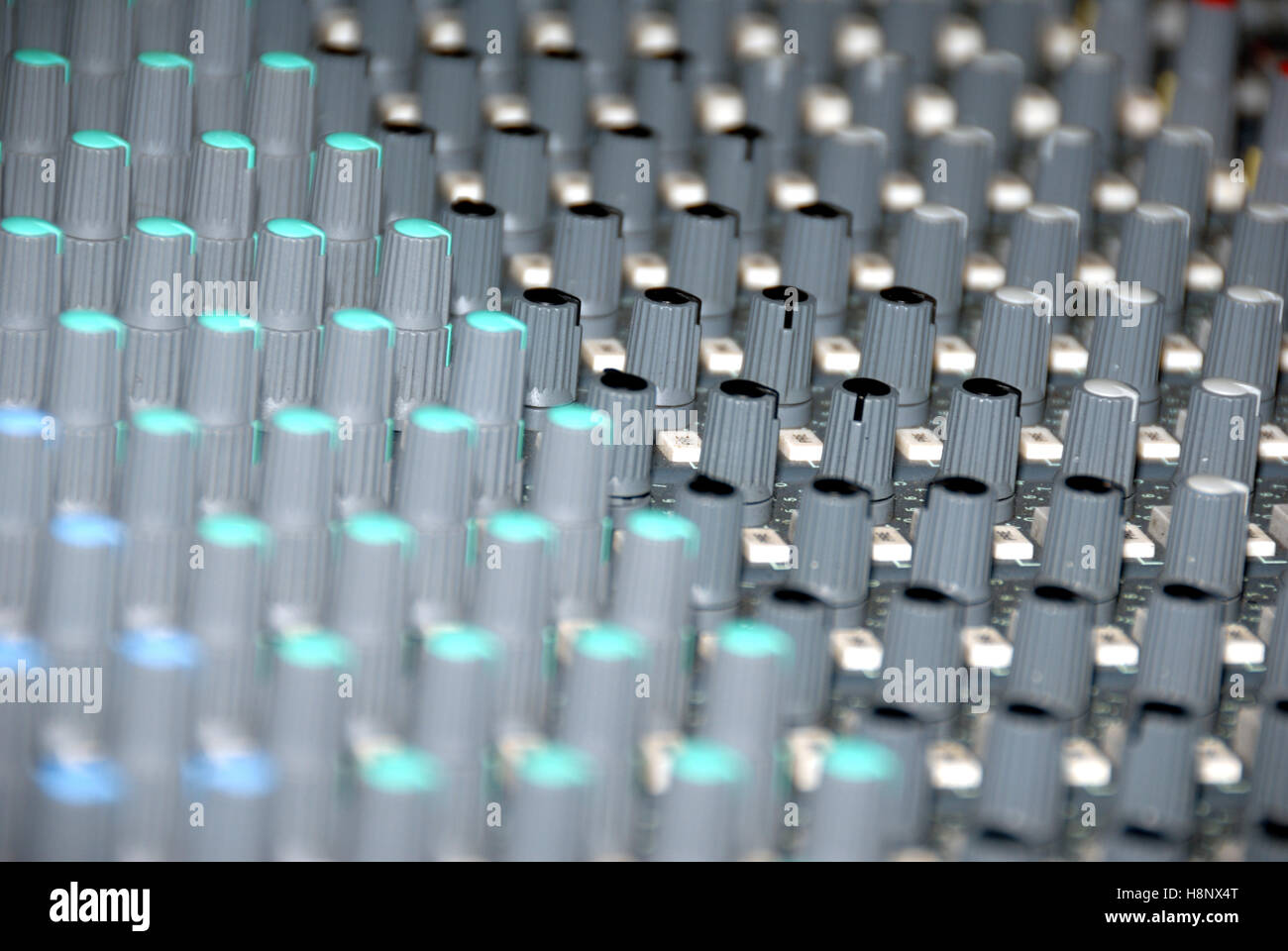 Audio mixing console in a recording studio. Faders and knobs of a sound ...