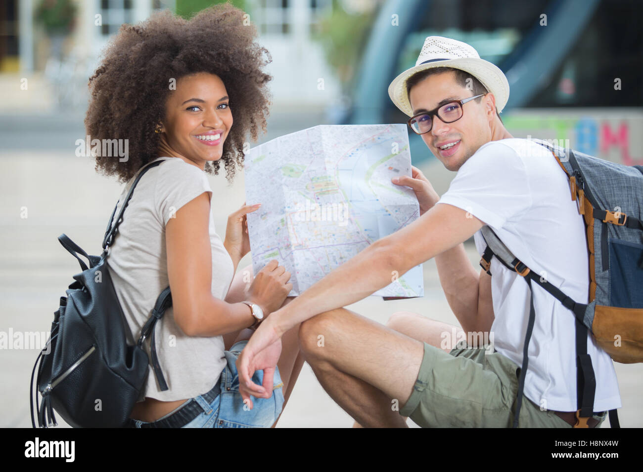 young happy couple checking a map Stock Photo - Alamy