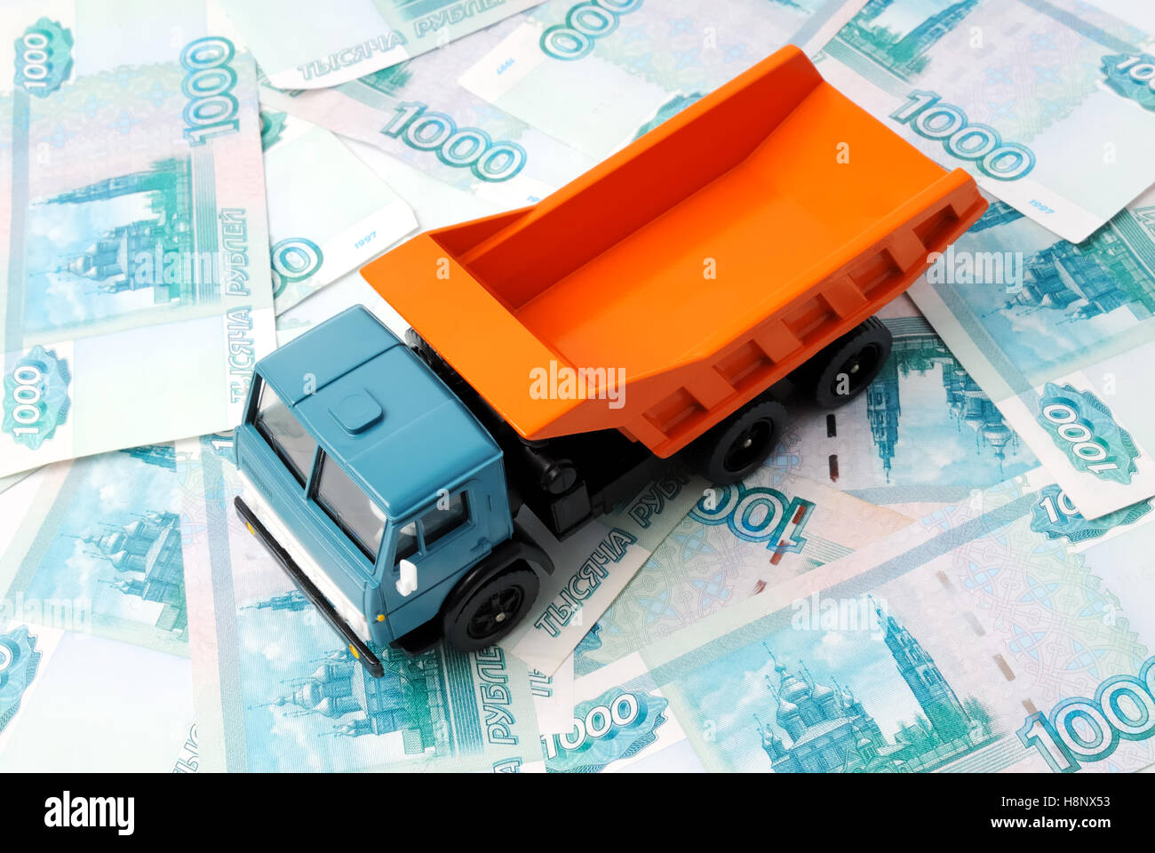Toy car on the background of banknotes Stock Photo - Alamy
