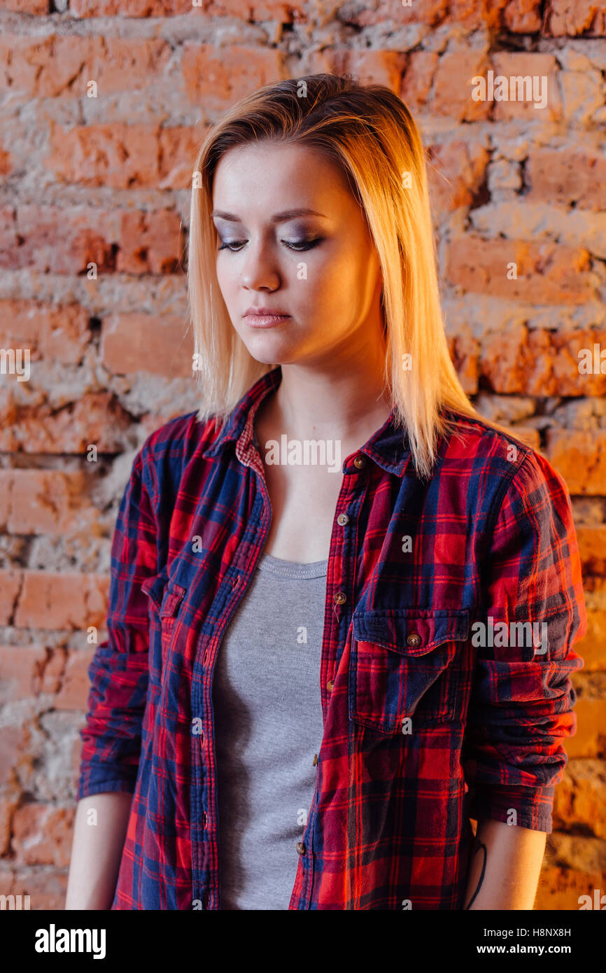 Pretty hipster girl near the brick wall in loft style room Stock Photo ...