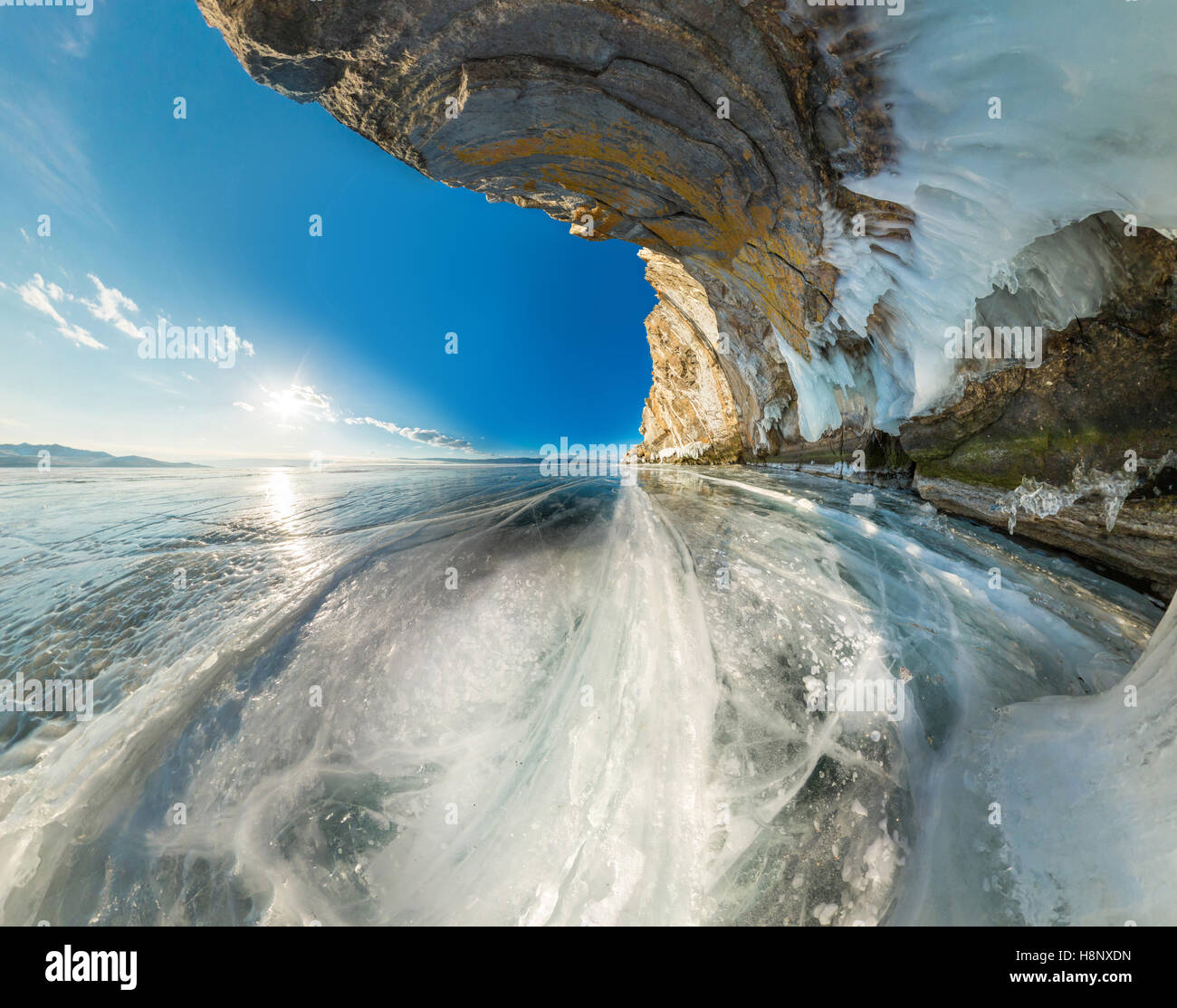 Ice grotto in rock on Olkhon Island on Lake Baikal ice covered wide ...