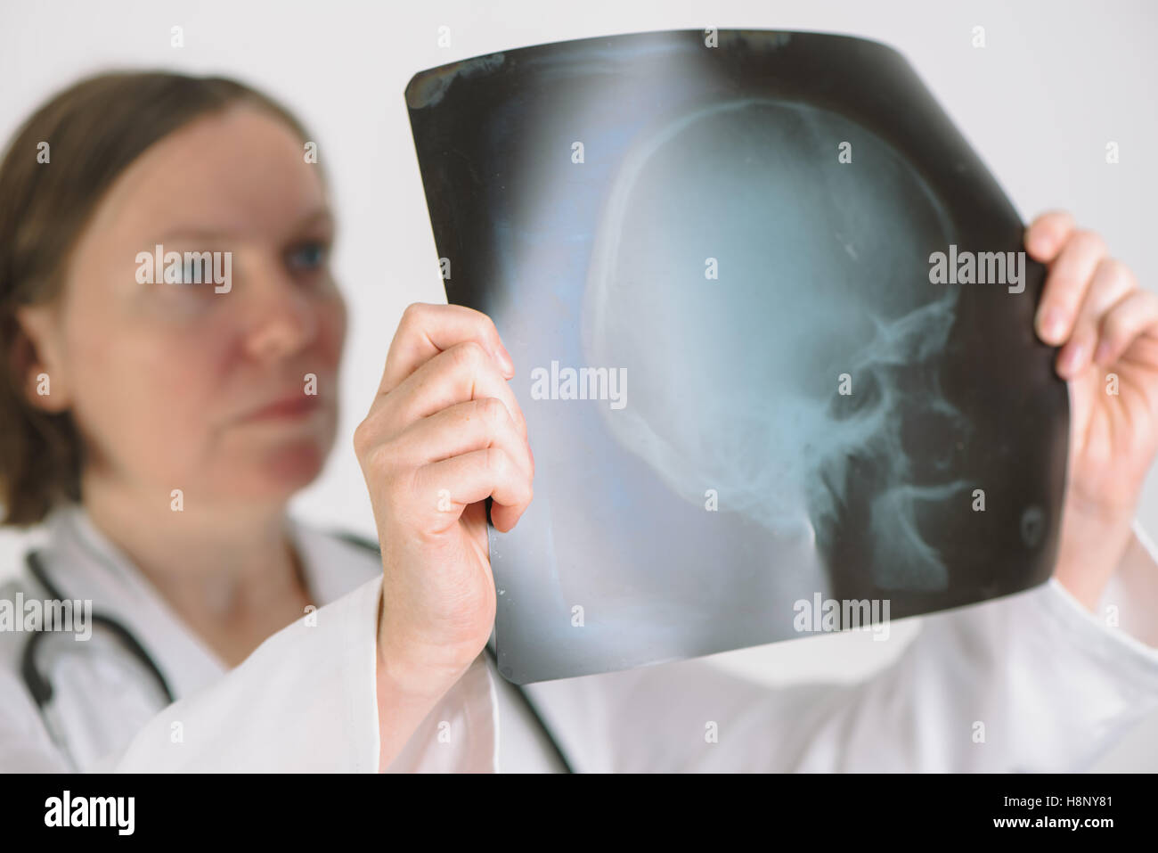 Doctor analyzing human skull x-ray screening image in hospital office ...