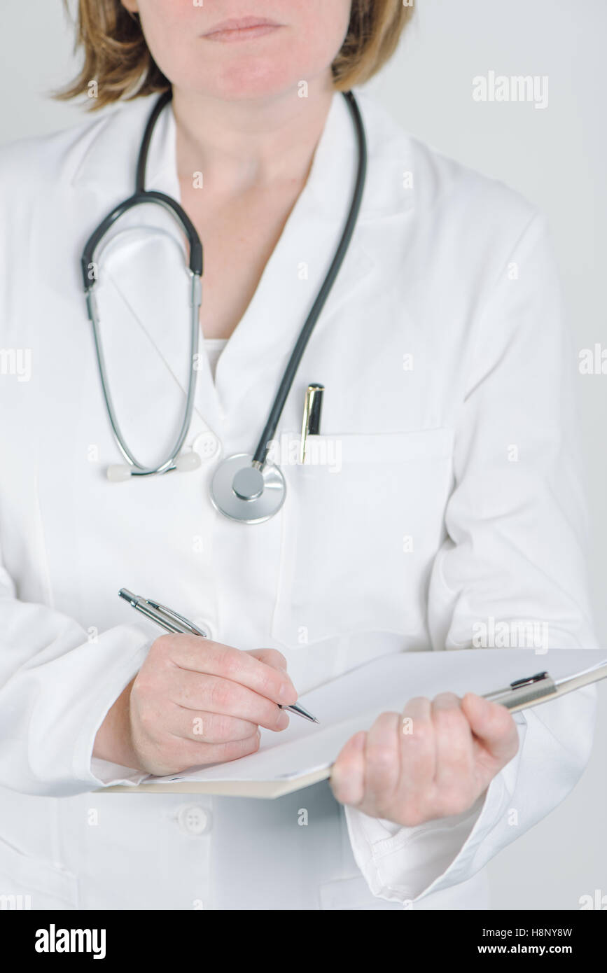 Female doctor writing on clipboard notepad blank paper medical advice ...
