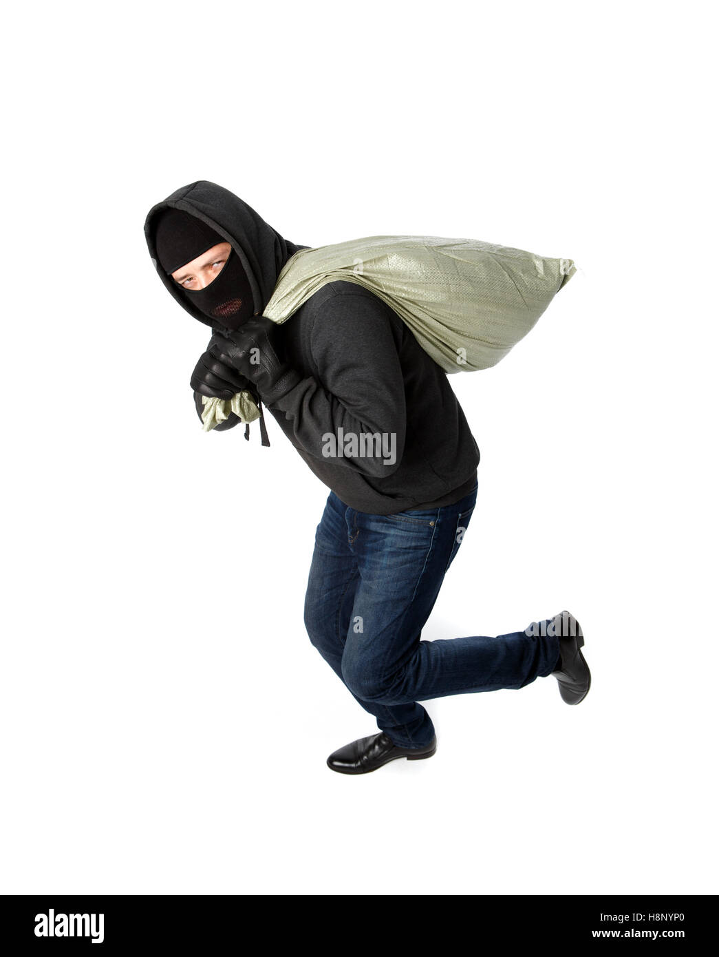 Thief running with heavy black bag on shoulder on pure white background ...