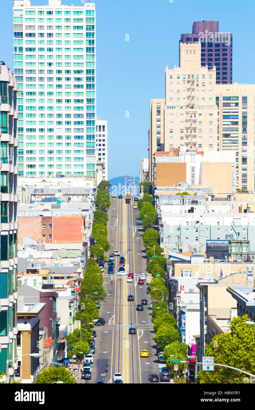 Distant telephoto view down California Street of iconic cable car and ...