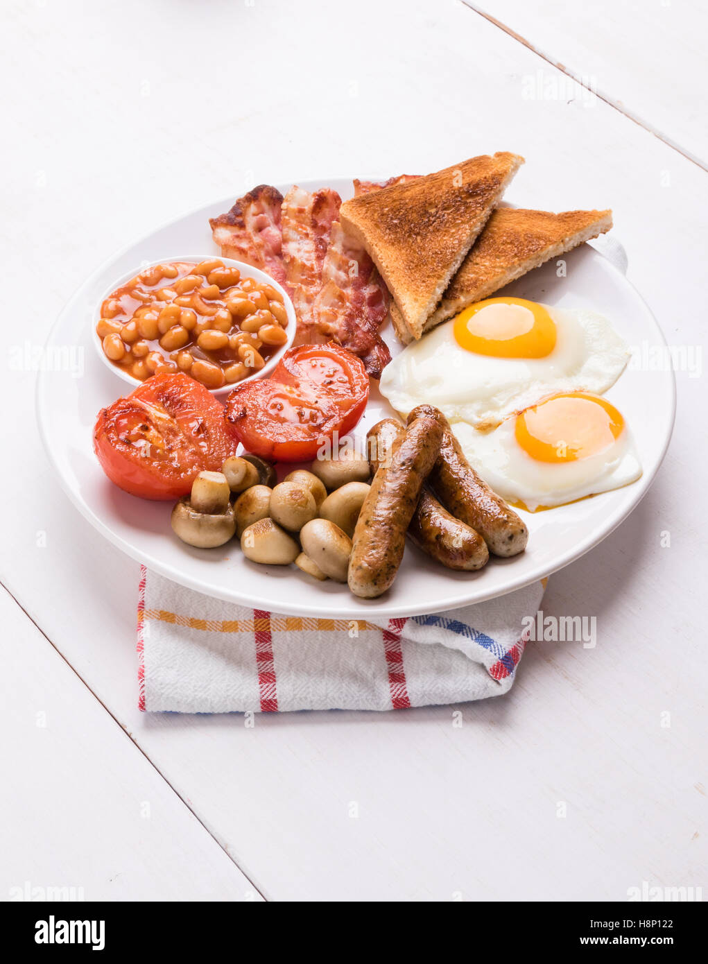 full english breakfast with bacon, sausage, eggs, beans, mushrooms, on ...