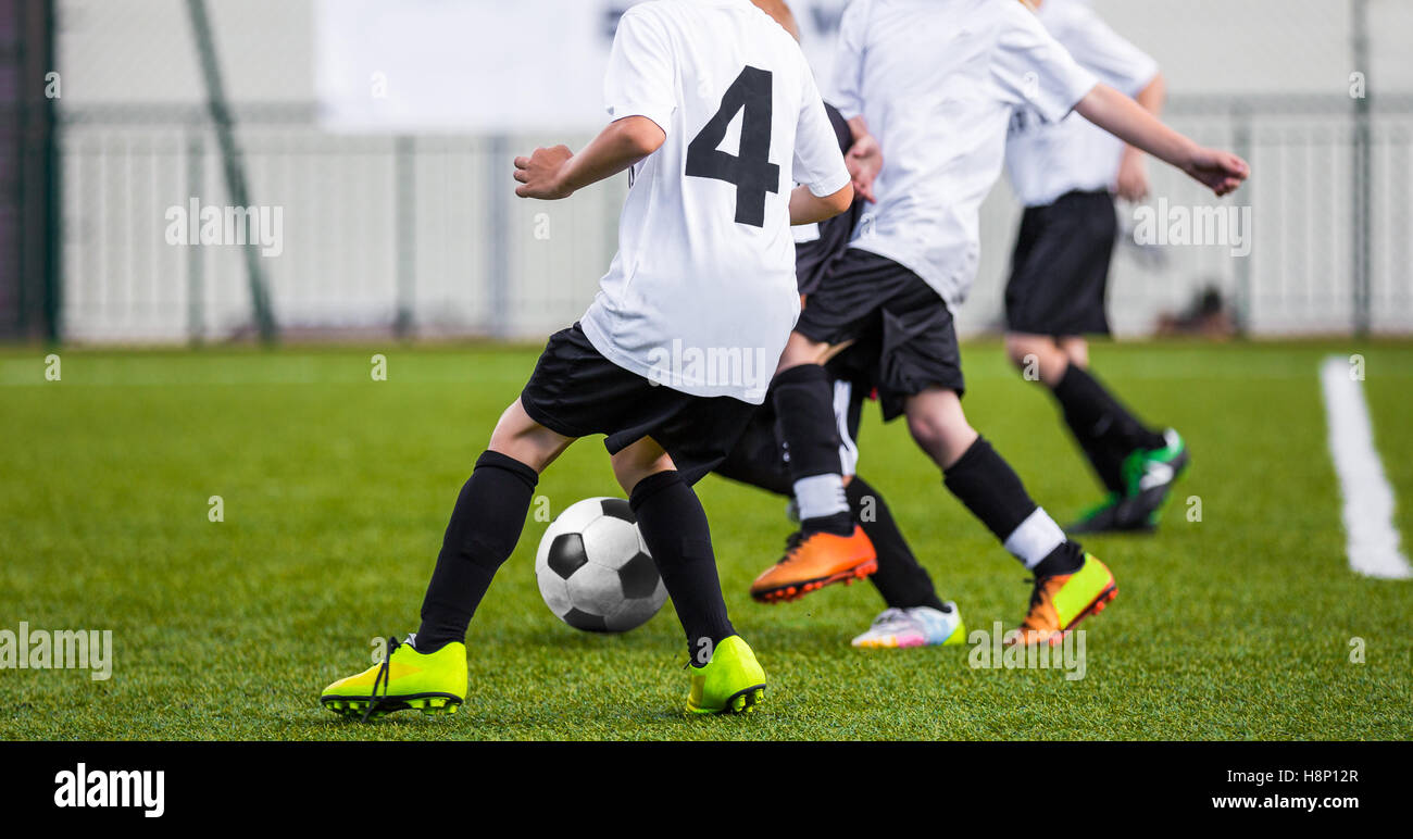 Kids play soccer football game Stock Photo - Alamy