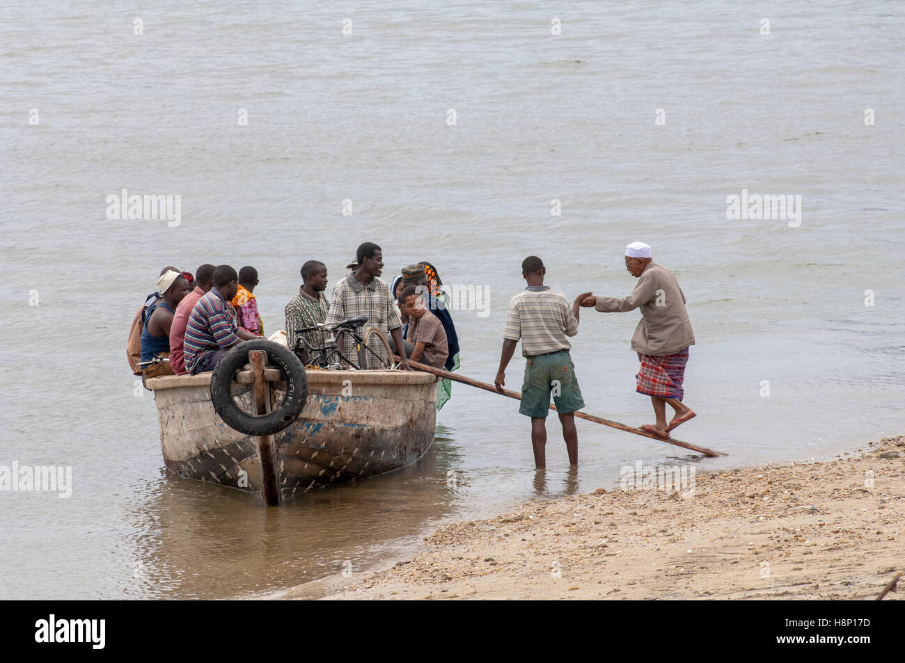 Old man helped to board a ferry boat, Pangani River, Tanga region ...