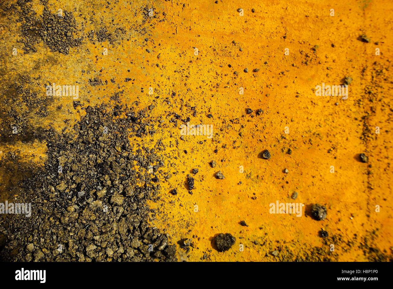 Weathered industrial yellow metal with gravel Stock Photo - Alamy