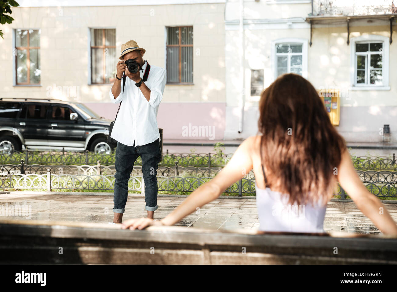 Pretty photo session in park. with african photographer Stock Photo - Alamy
