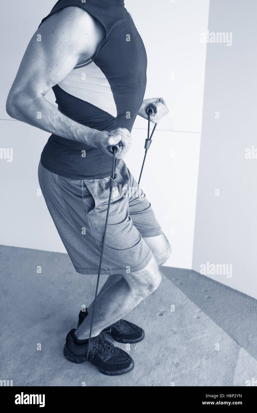 Performing exercises with resistance rope fitness Stock Photo - Alamy