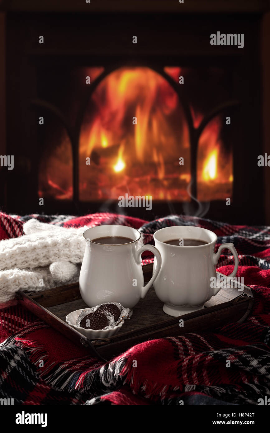 Hot chocolate drinks by the fireside Stock Photo - Alamy