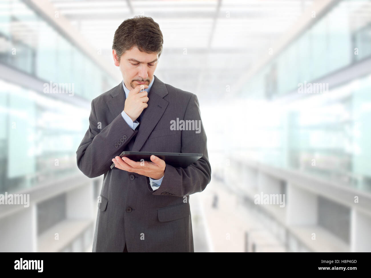 businessman working with a tablet pc, at the office Stock Photo - Alamy