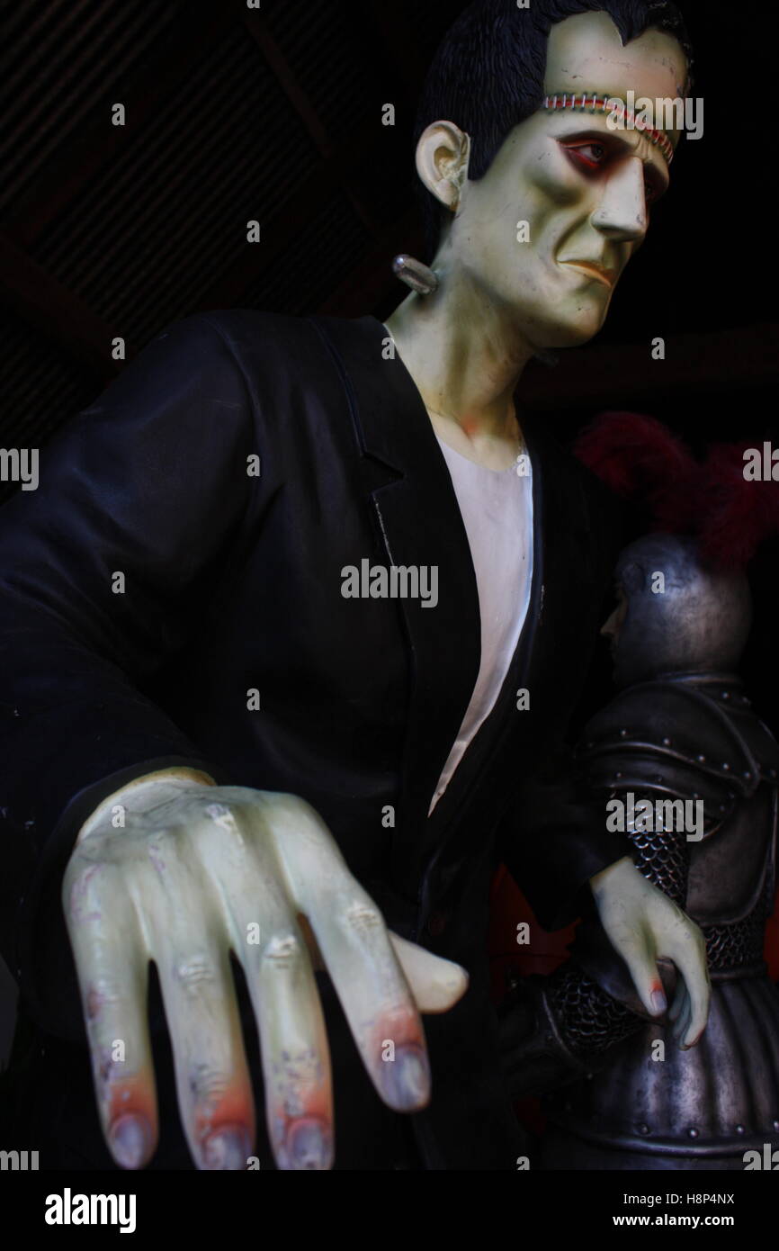 Frankenstein statue in front of a knight statue in storage Stock Photo ...