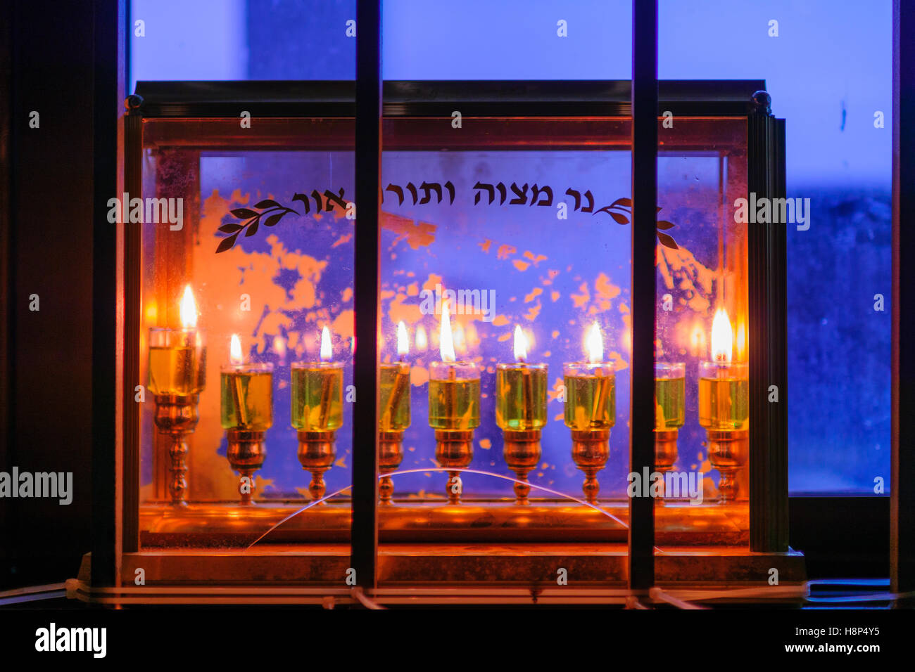 Traditional Menorah (Hanukkah Lamp) with olive oil candles. Text is ...