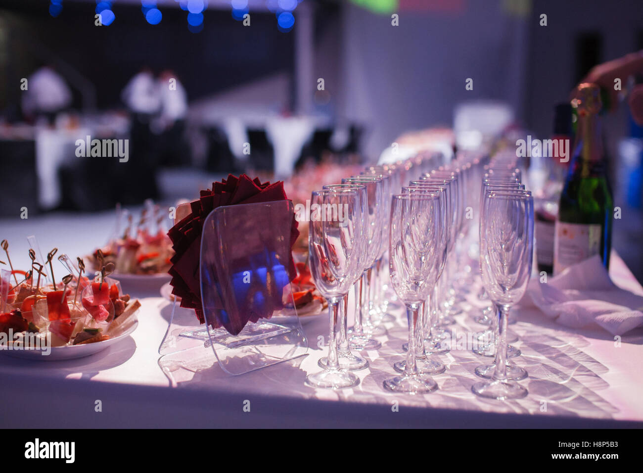 Catering banquet table with baked food snacks, sandwiches, cakes, cups ...