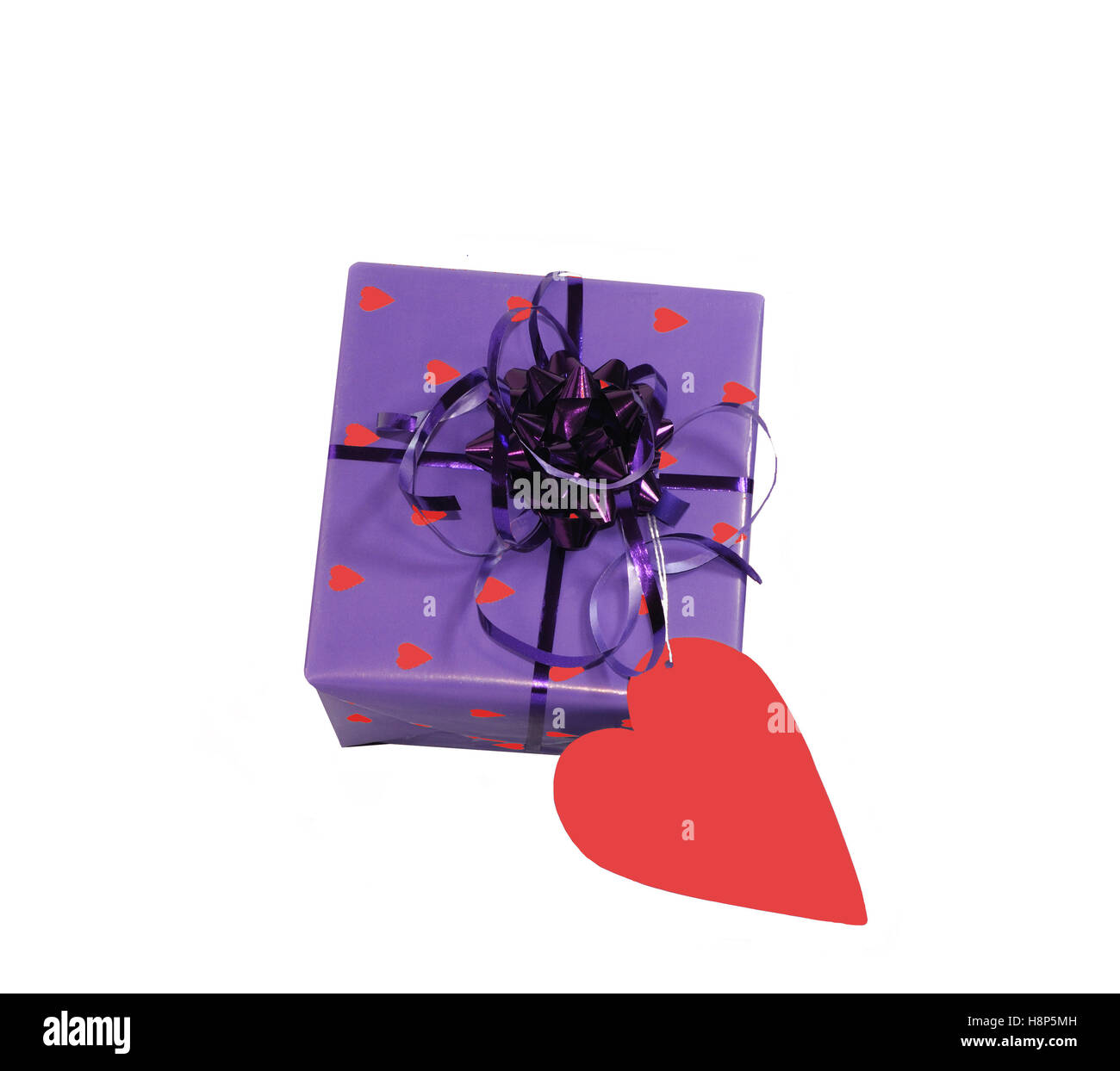 Valentine gift wrapped in purple paper with red hearts, ribbon and bow ...