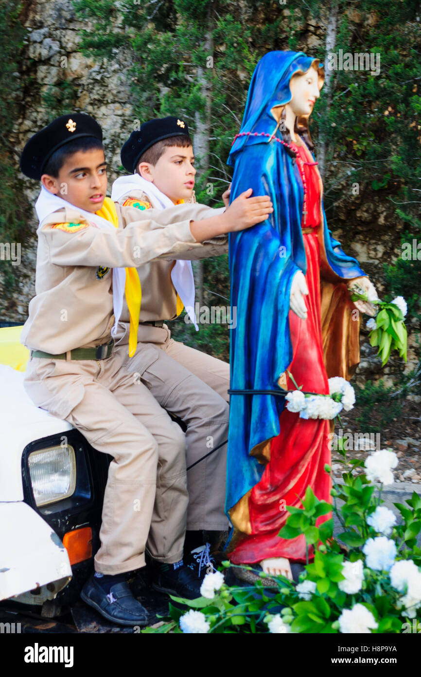 HAIFA, ISRAEL - APR 19, 2015: Young Christian scouts hold a statue of ...