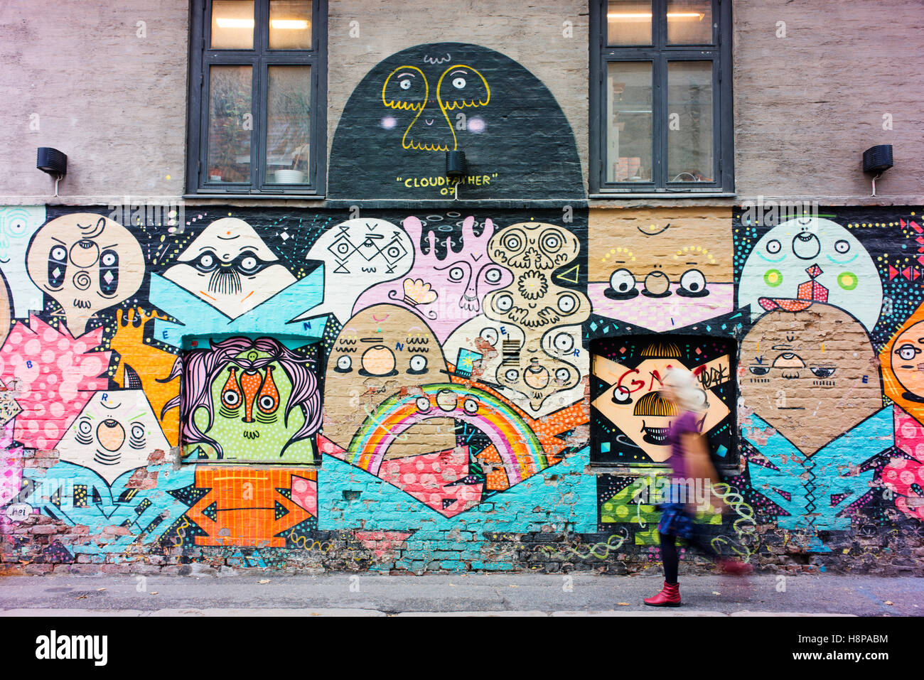 Woman walks past street art in Oslo Stock Photo - Alamy