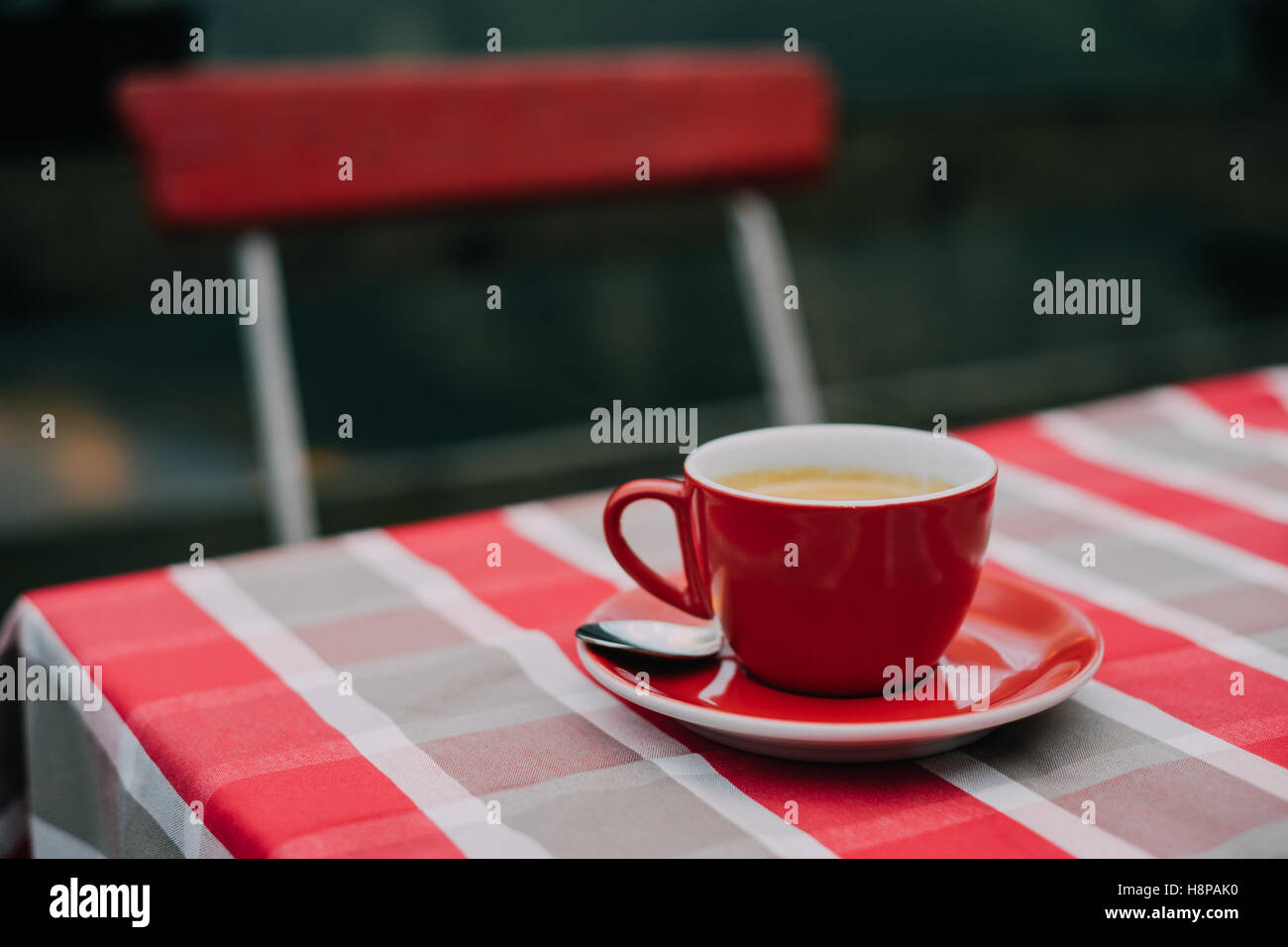 Coffee in red cup on italian style restaurant table, red and white ...