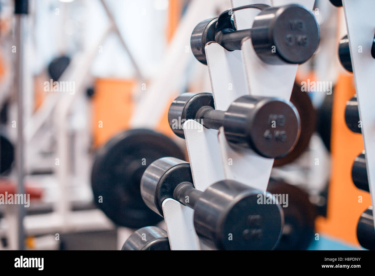 Dumbbells on a rack in a gym Stock Photo - Alamy