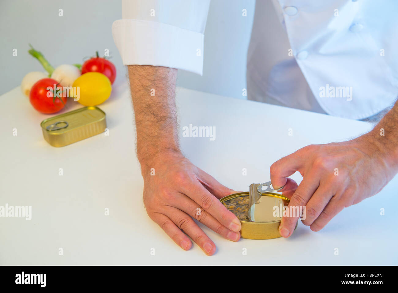 Chef opening a can Stock Photo - Alamy