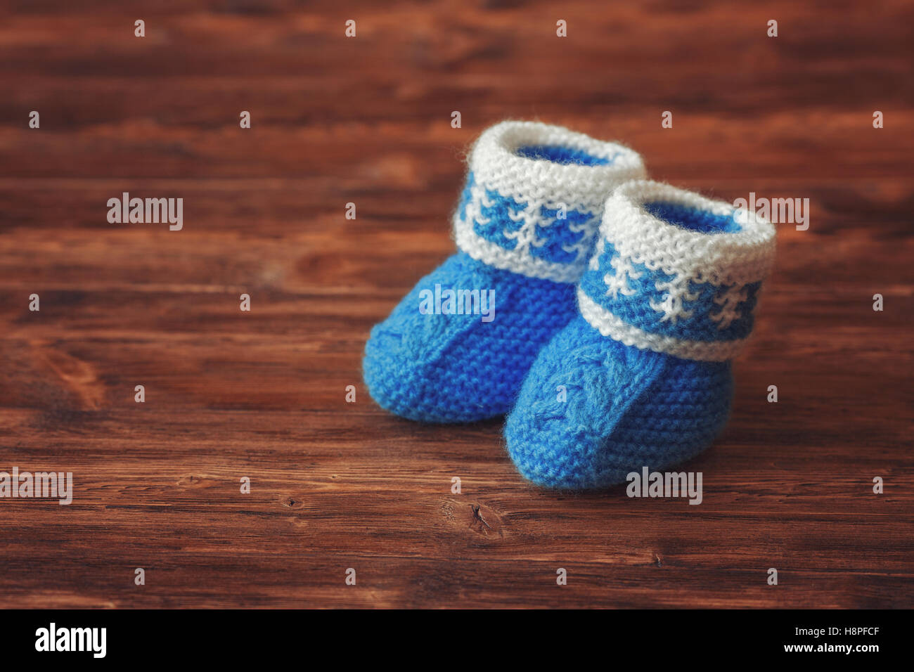 Blue crochet baby booties on wooden background, copyspace, vintage ...
