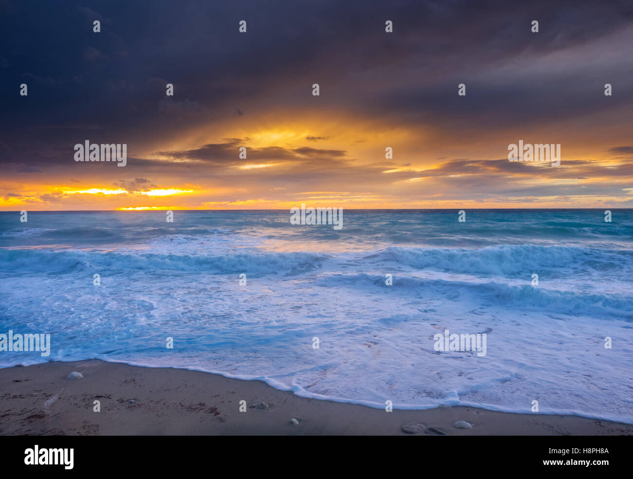 Sunset at the beach in Greece Stock Photo - Alamy