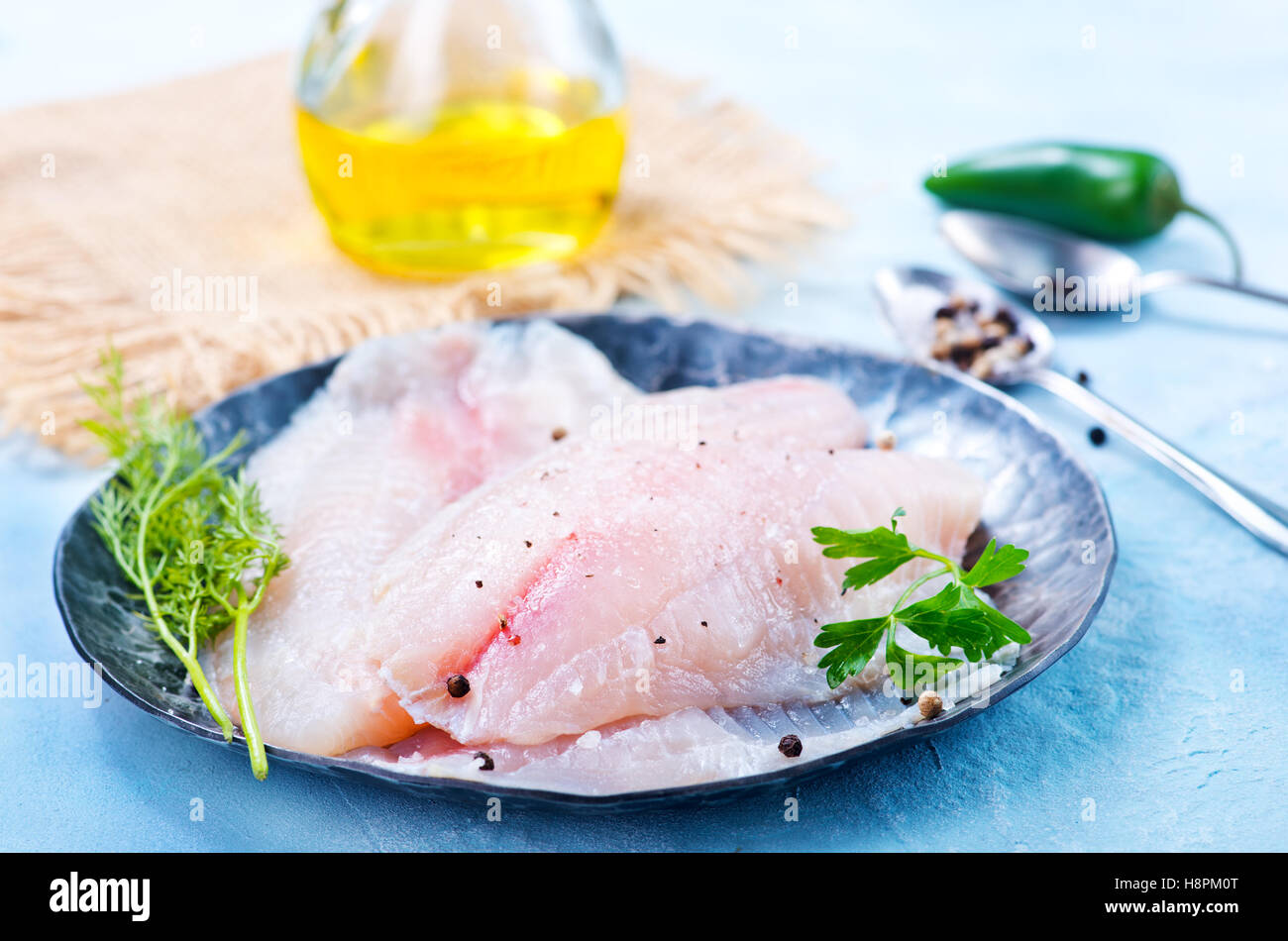 raw fish fillet on the metal plate Stock Photo - Alamy