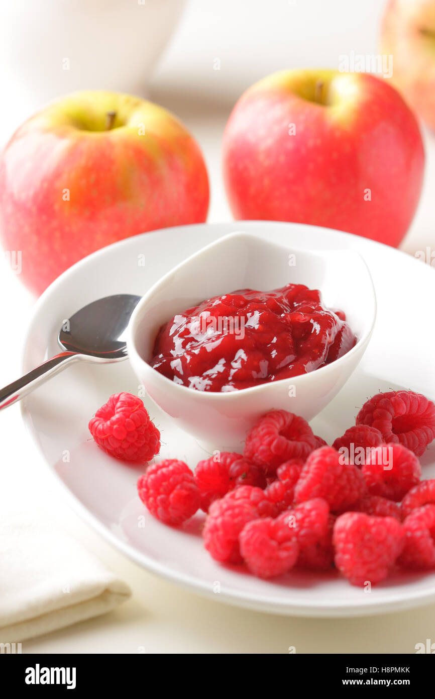 Raspberry and apple jam with fresh raspberries on the plate Stock Photo ...
