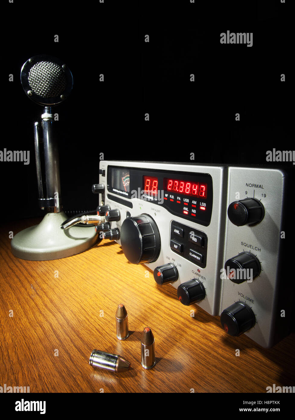 Two way radio and ammunition on a dark desk Stock Photo - Alamy