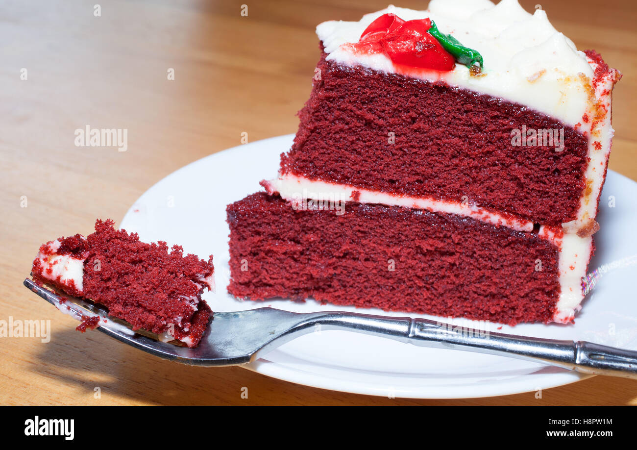 Fork full of red velvet cake and a slice on a white dish Stock Photo ...