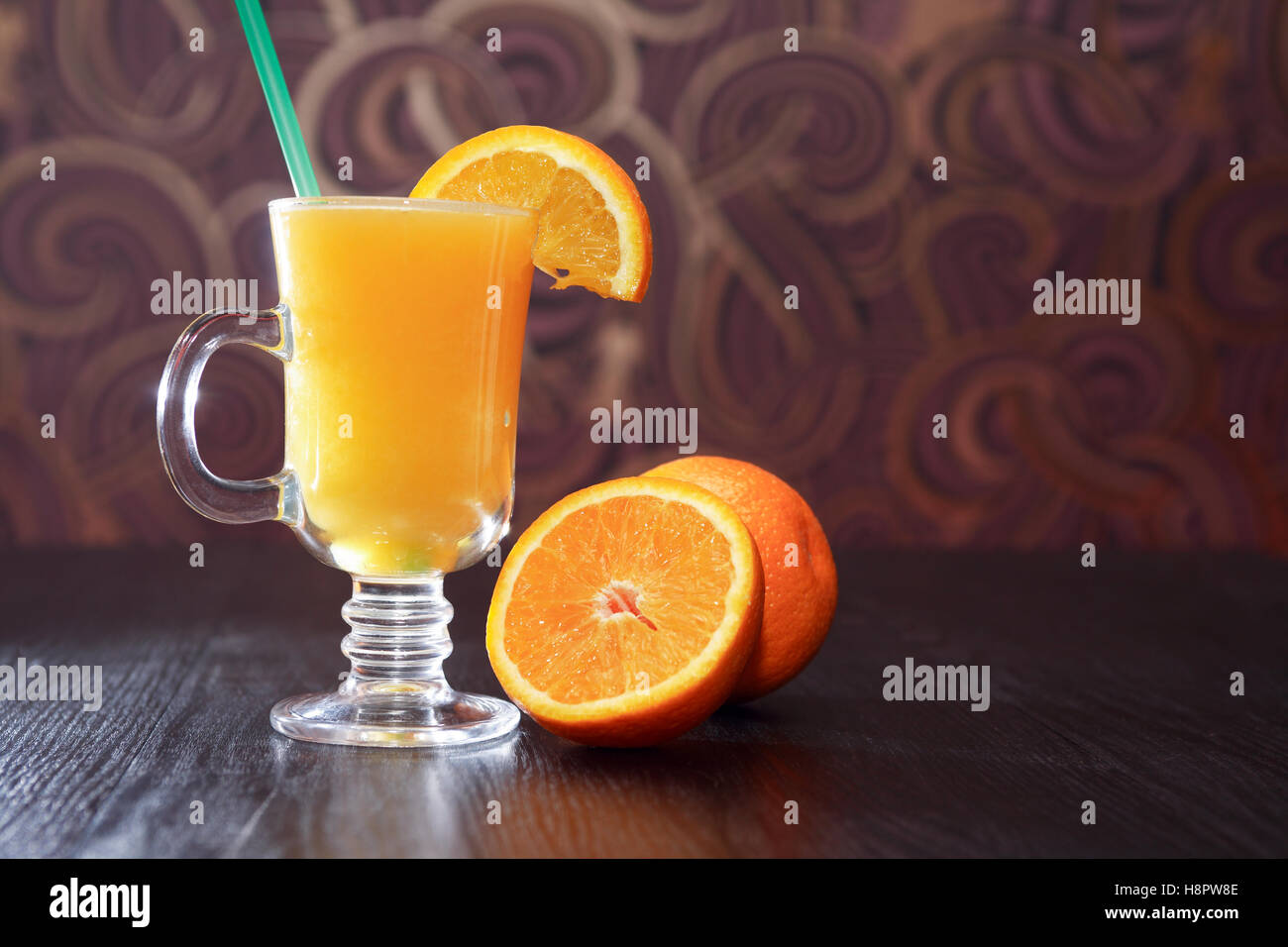 Nice goblet full of orange juice near fruits on table Stock Photo - Alamy