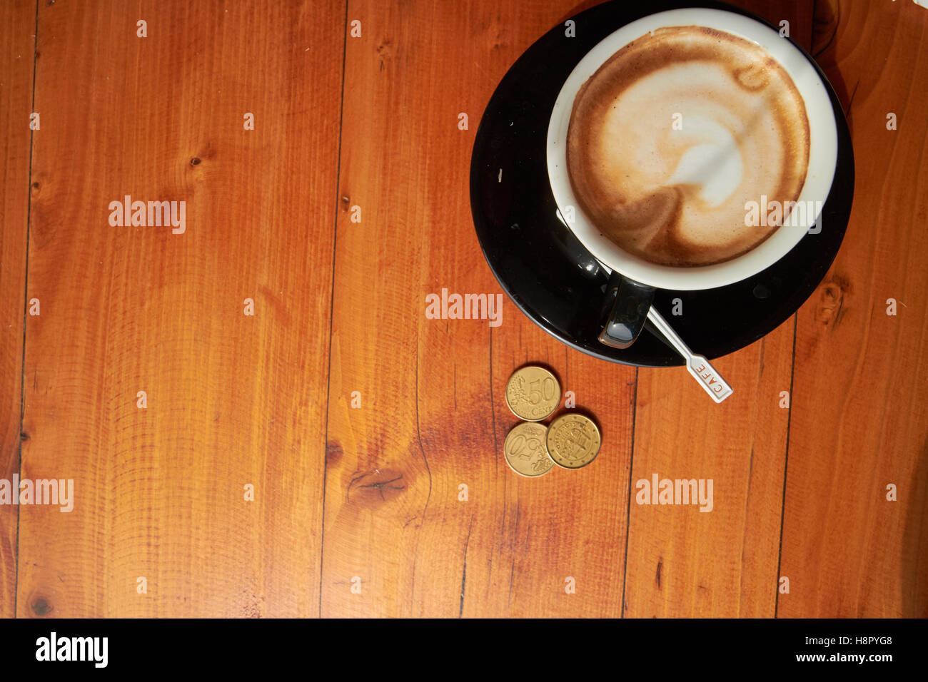 cup of coffee on the table and coins Stock Photo - Alamy