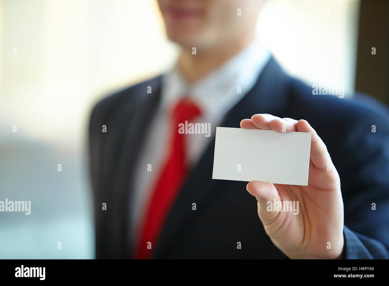 Businessman giving business card Stock Photo - Alamy