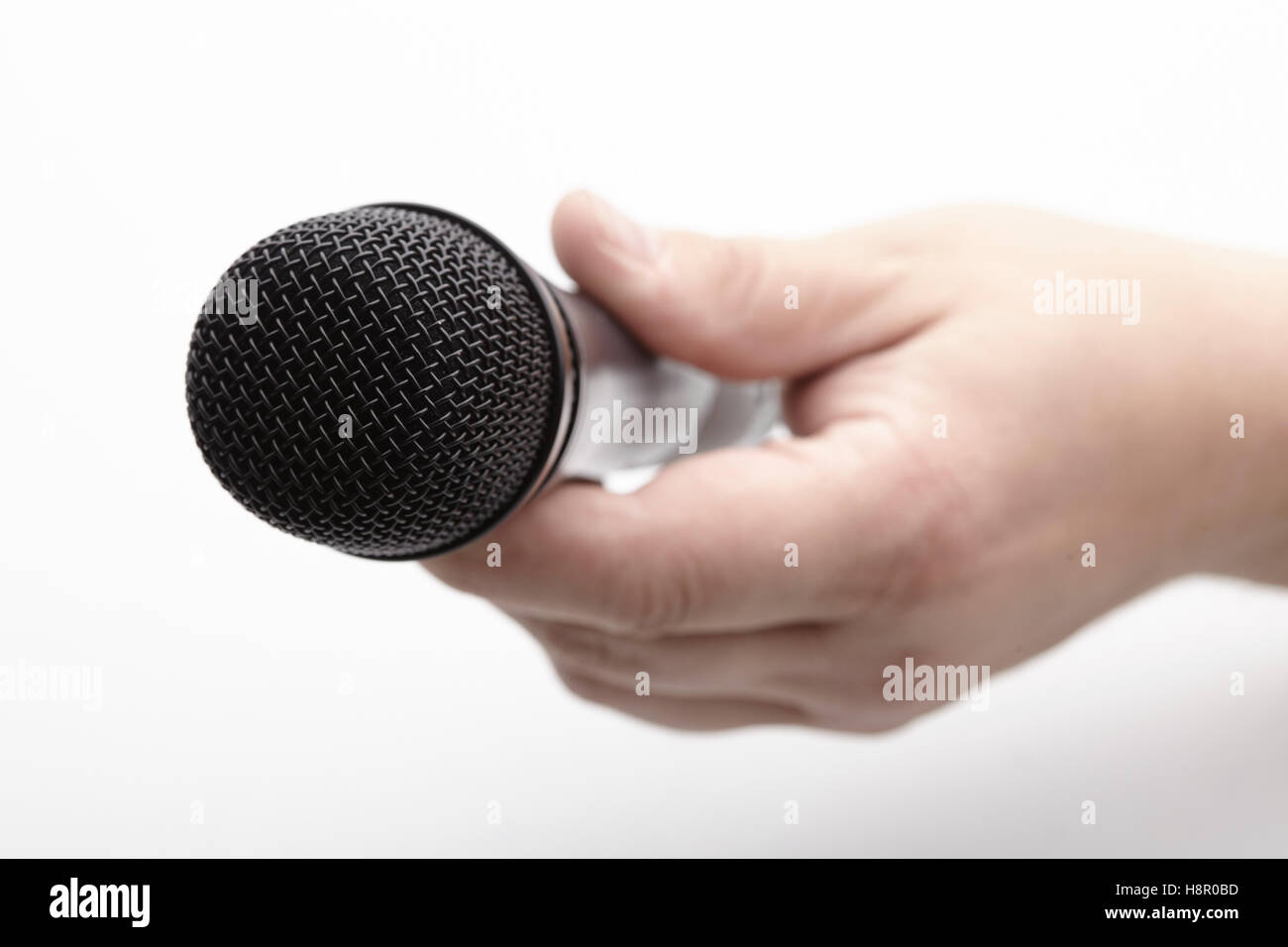 Microphone in a man's hand Stock Photo - Alamy