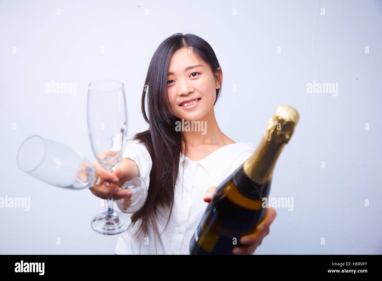 Chinese woman with champagne and glasses Stock Photo - Alamy