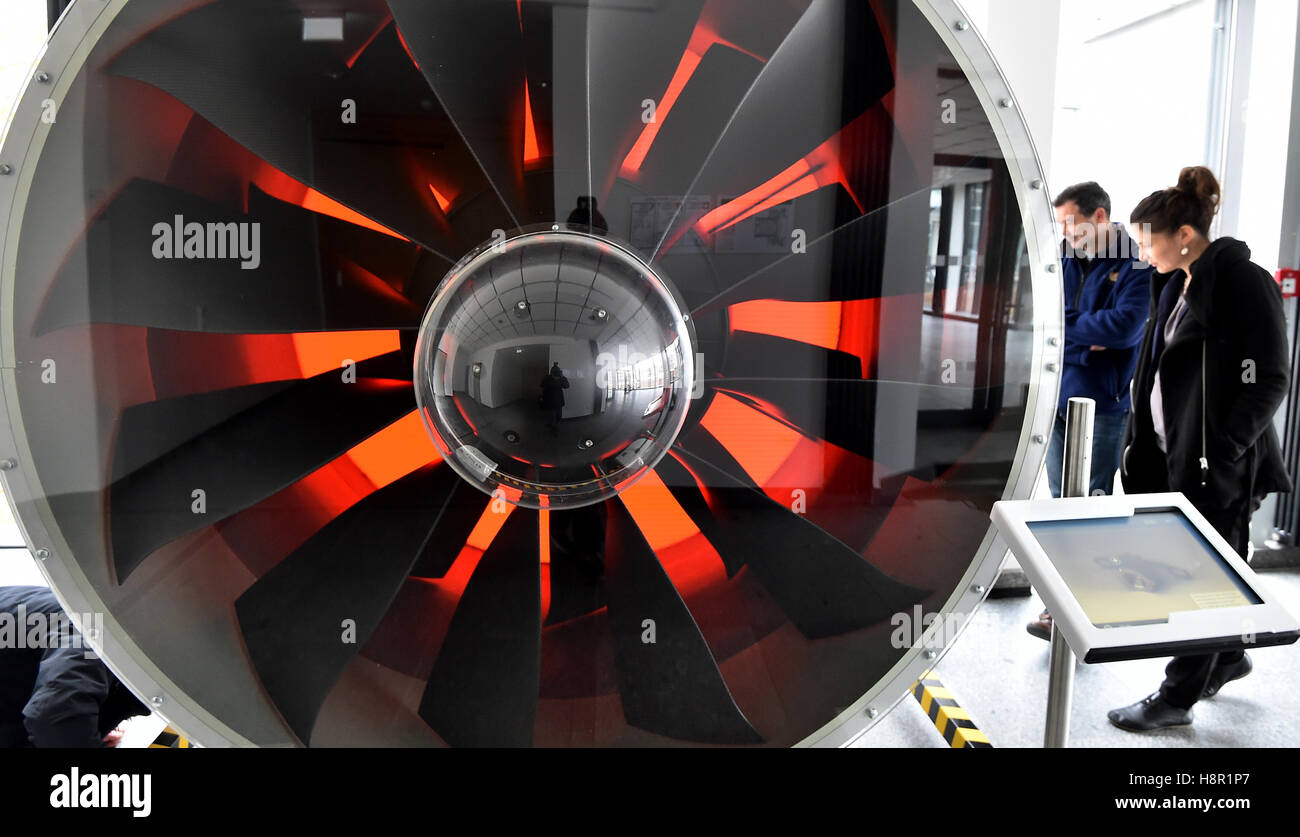 Students examine a Rolls-Royce jet propulsion engine displayed in the ...