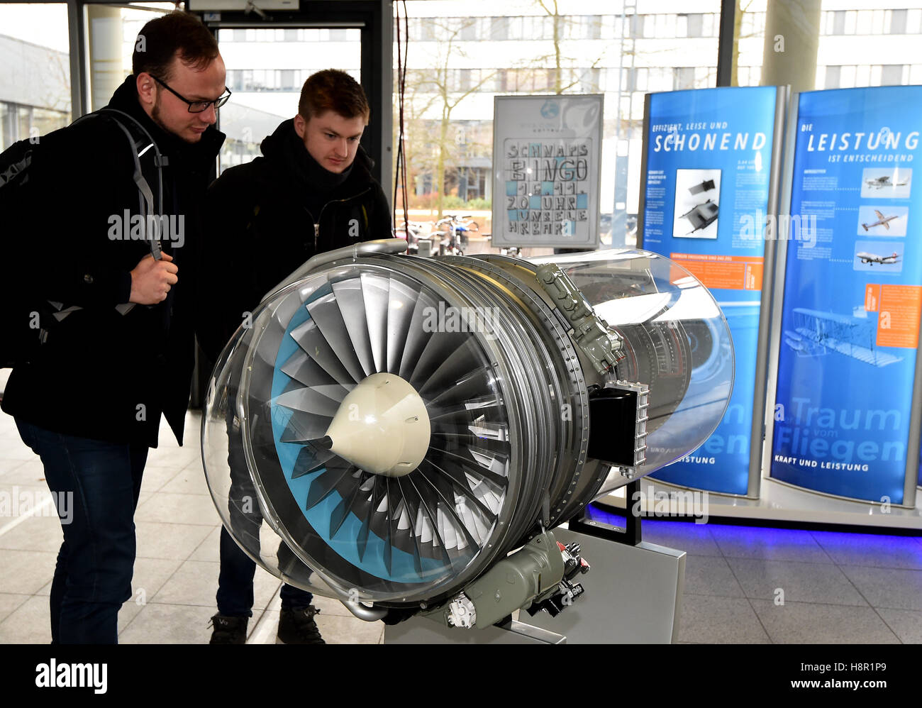 Students examine a Rolls-Royce jet propulsion engine displayed in the ...