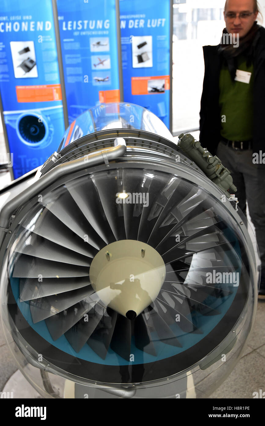 Students examine a Rolls-Royce jet propulsion engine displayed in the ...