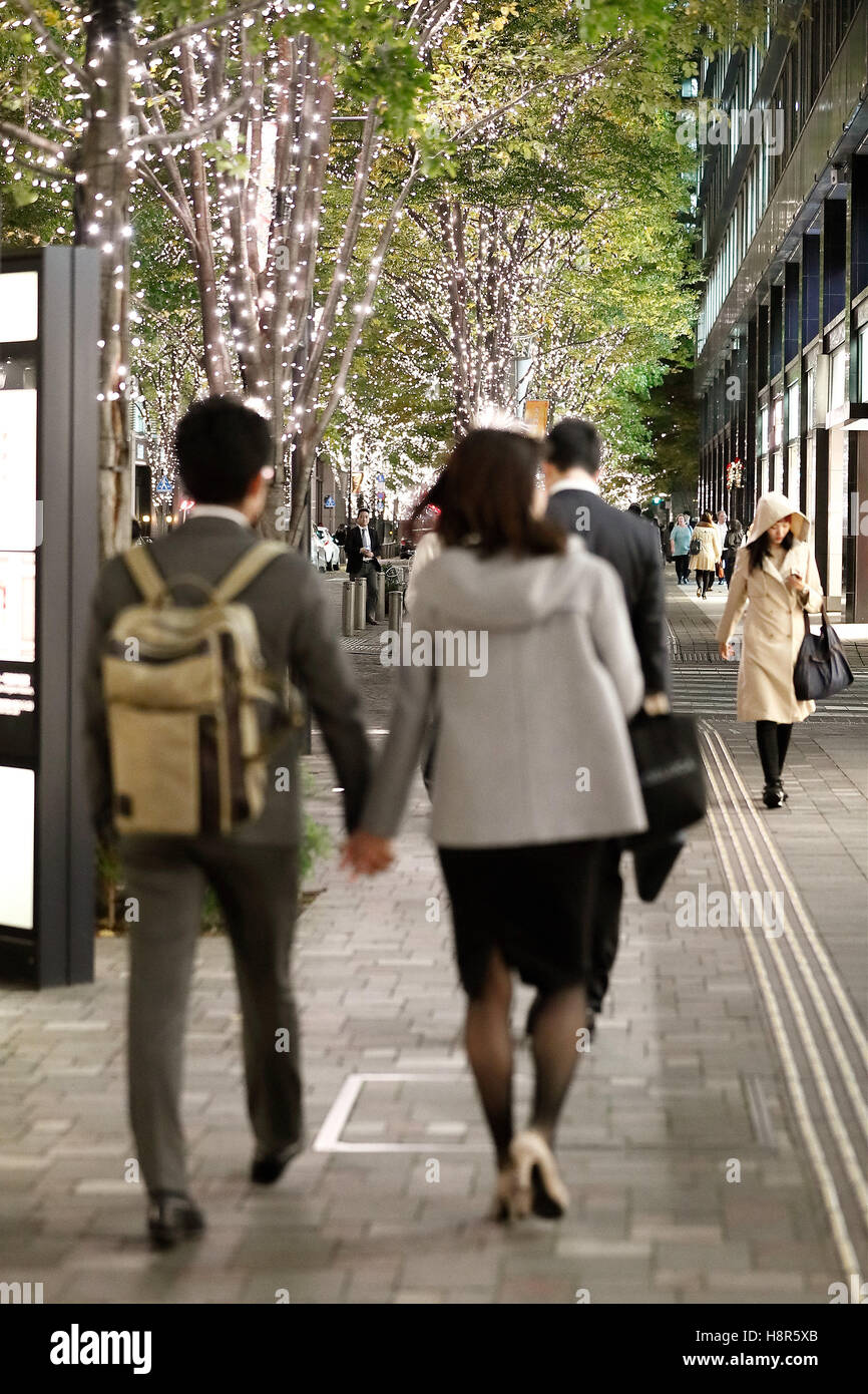 A couple walks past the LED lights illuminating the Marunouchi business ...