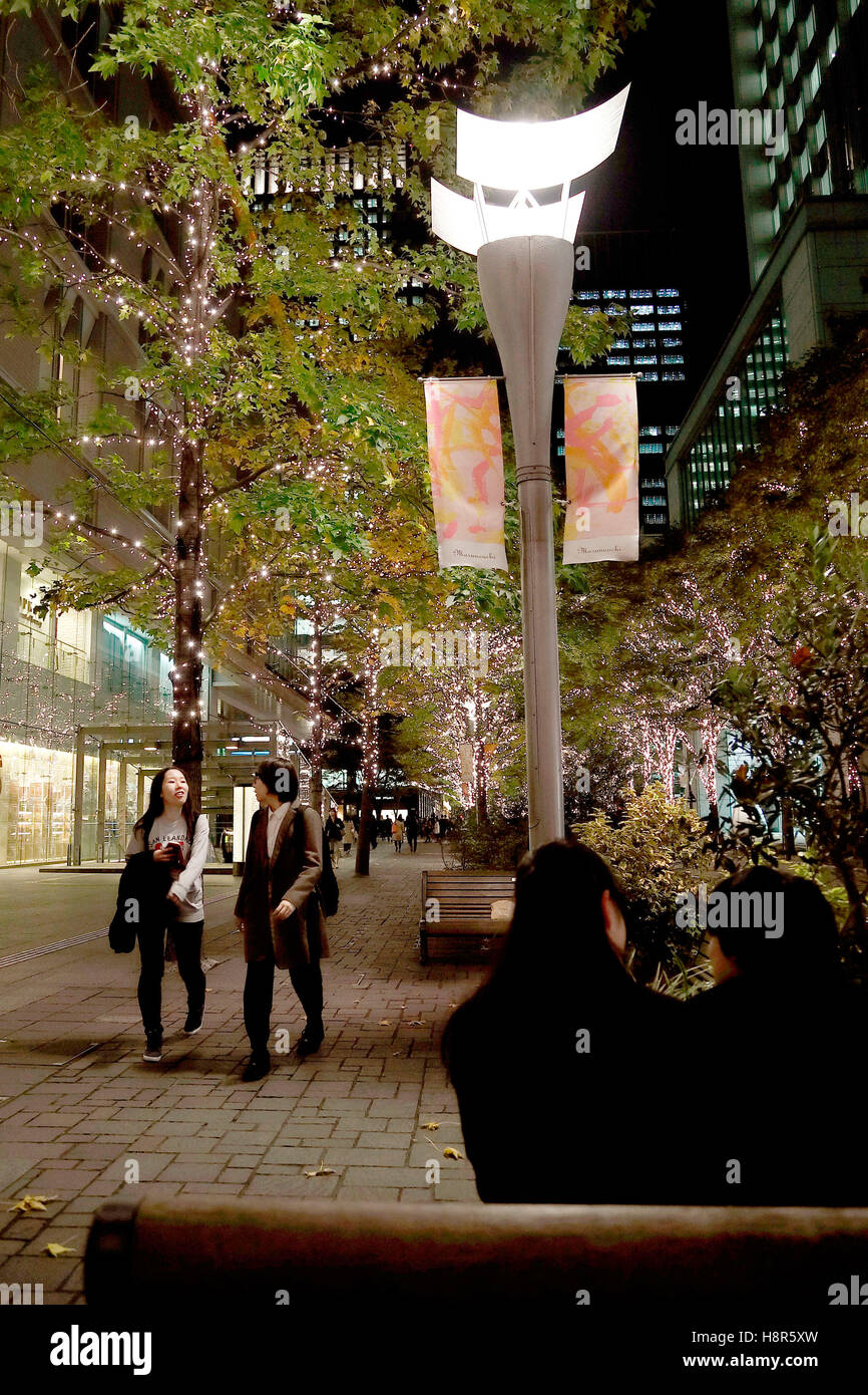 Pedestrians walk past the LED lights illuminating the Marunouchi ...