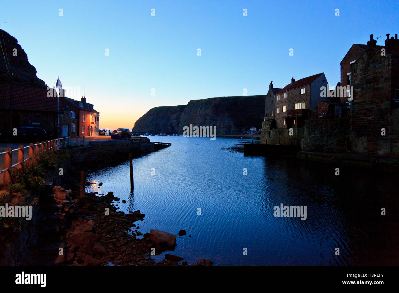Sunrise as Roxby Beck runs through the old fishing village of Staithes ...