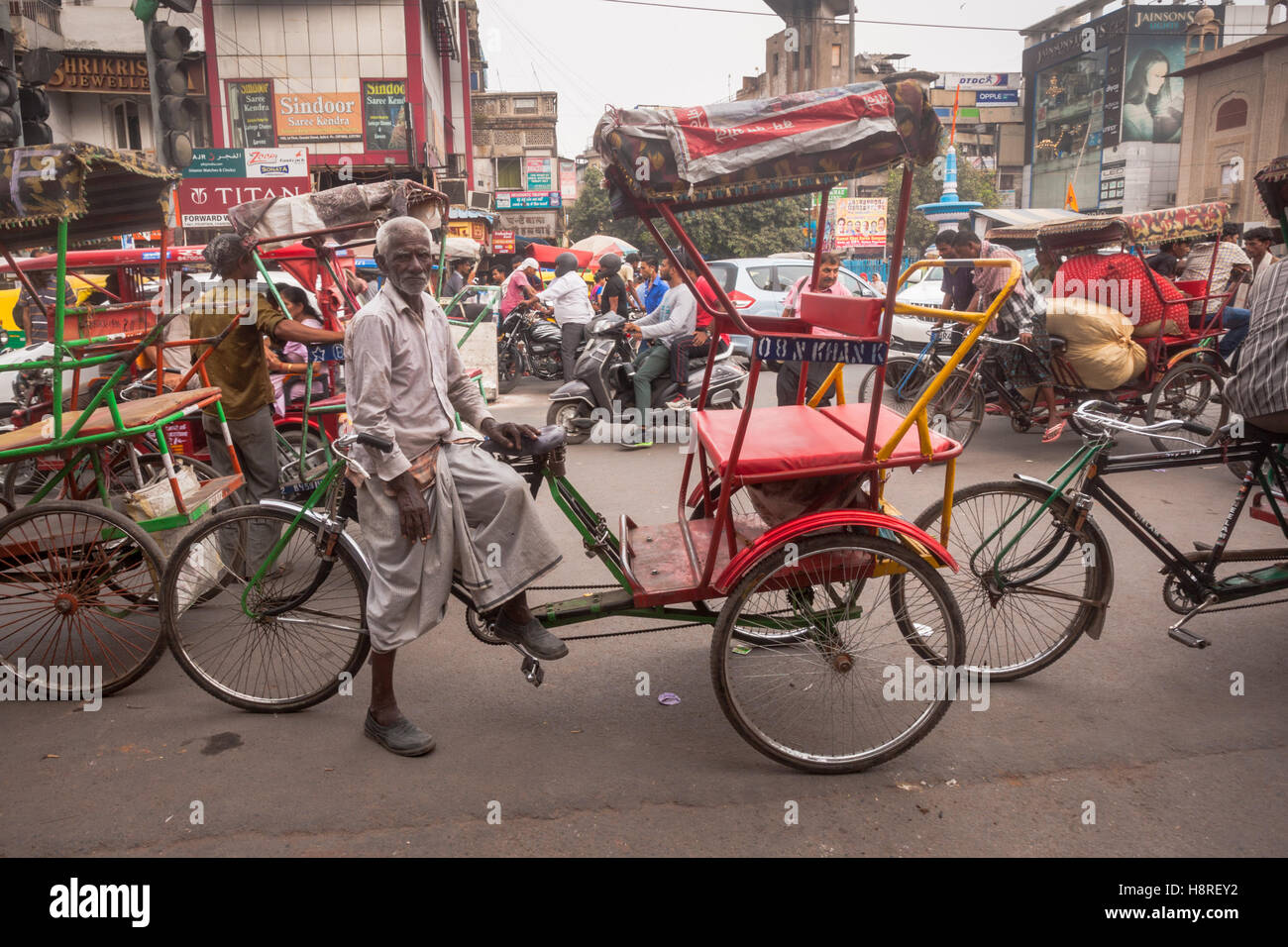 Cycle rickshaw drivers waiting for custom in a street in Old Delhi ...