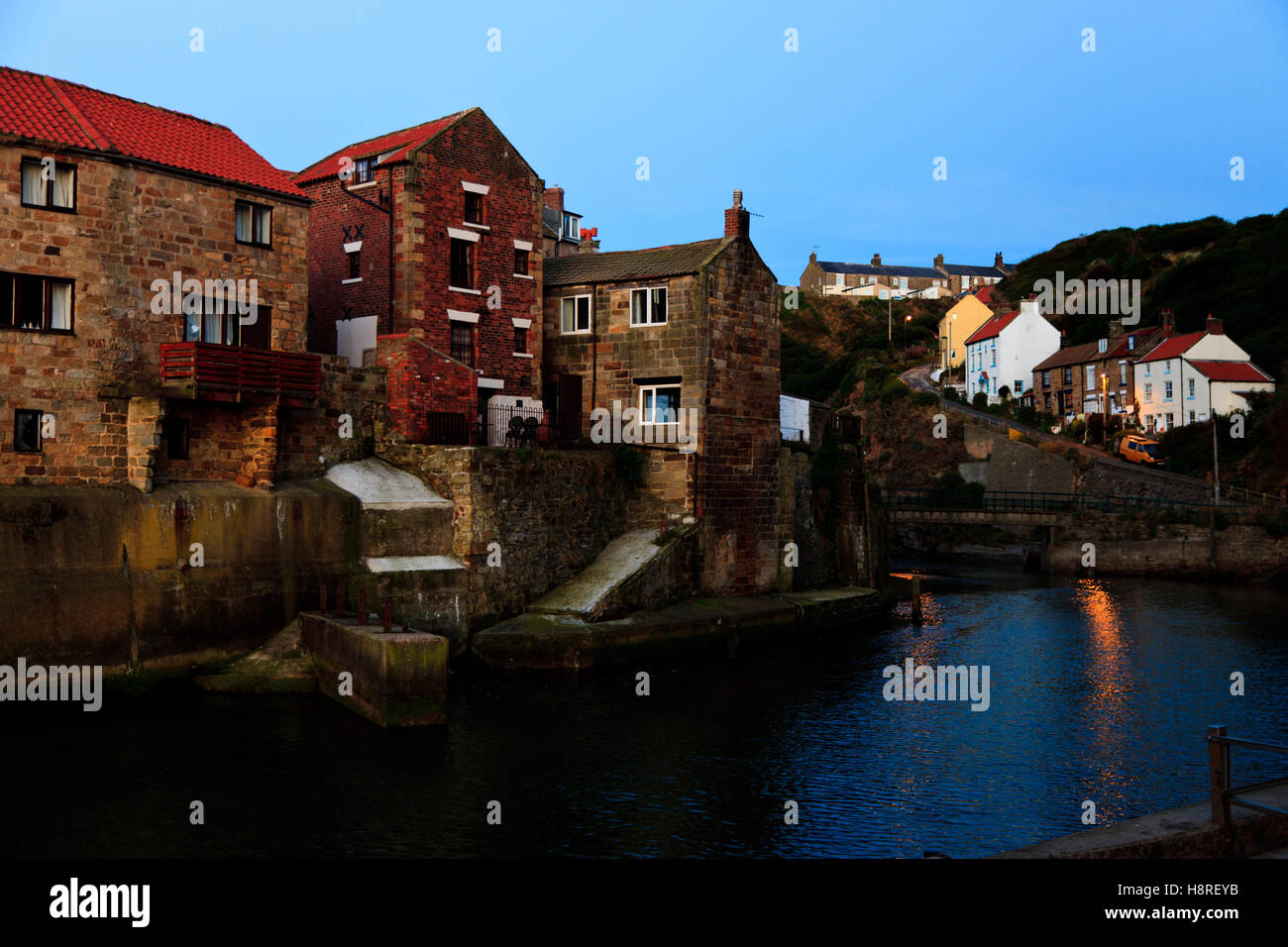 Sun rise as Roxby Beck runs through the old fishing village of Staithes ...